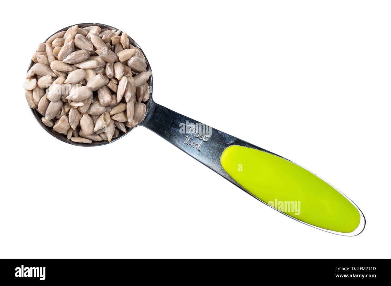 top view of peeled sunflower seeds in measuring spoon cutout on white ...