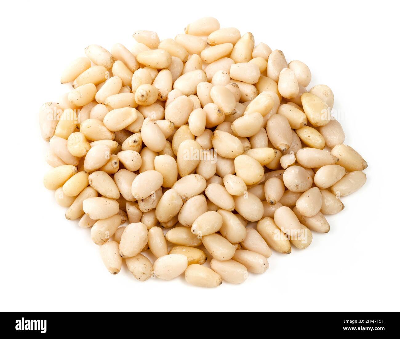 pile of unpeeled pine nuts closeup on white background Stock Photo - Alamy