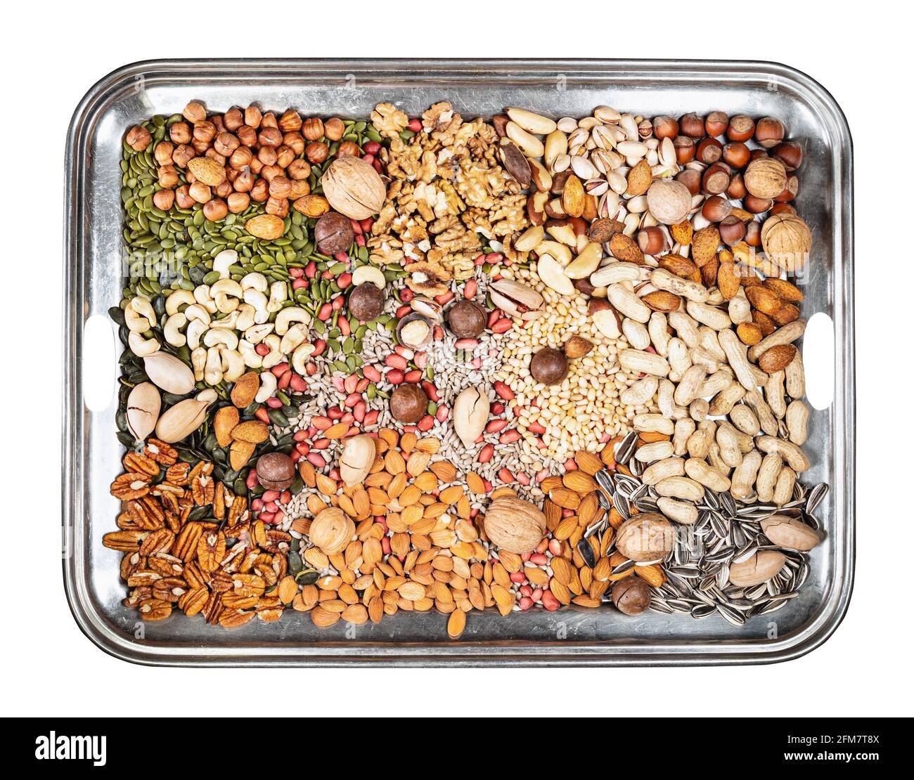 top view of steel tray with various shelled nuts and seeds cutout on ...