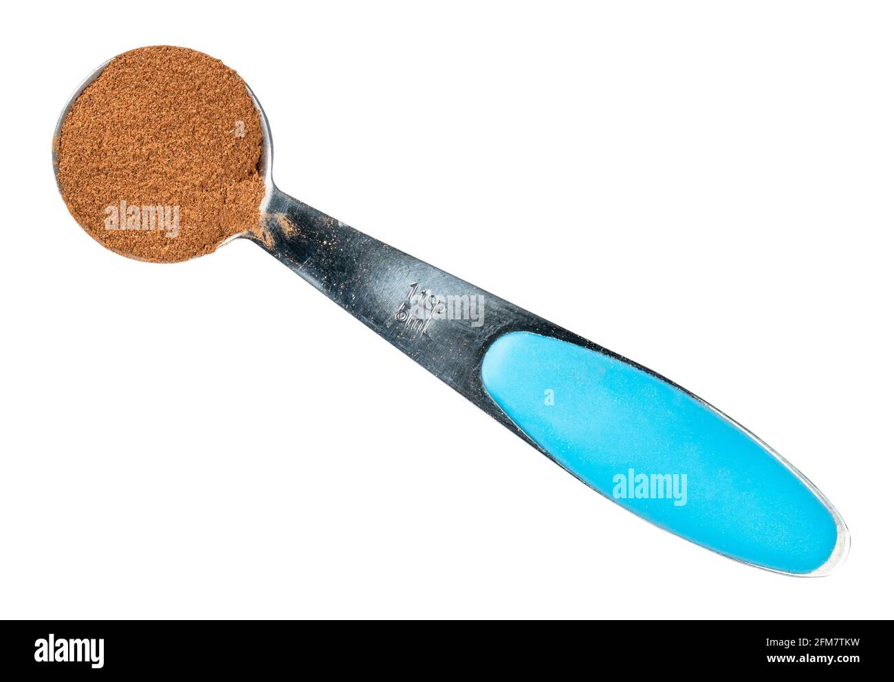 top view of cinnamon powder in measuring teaspoon cutout on white ...