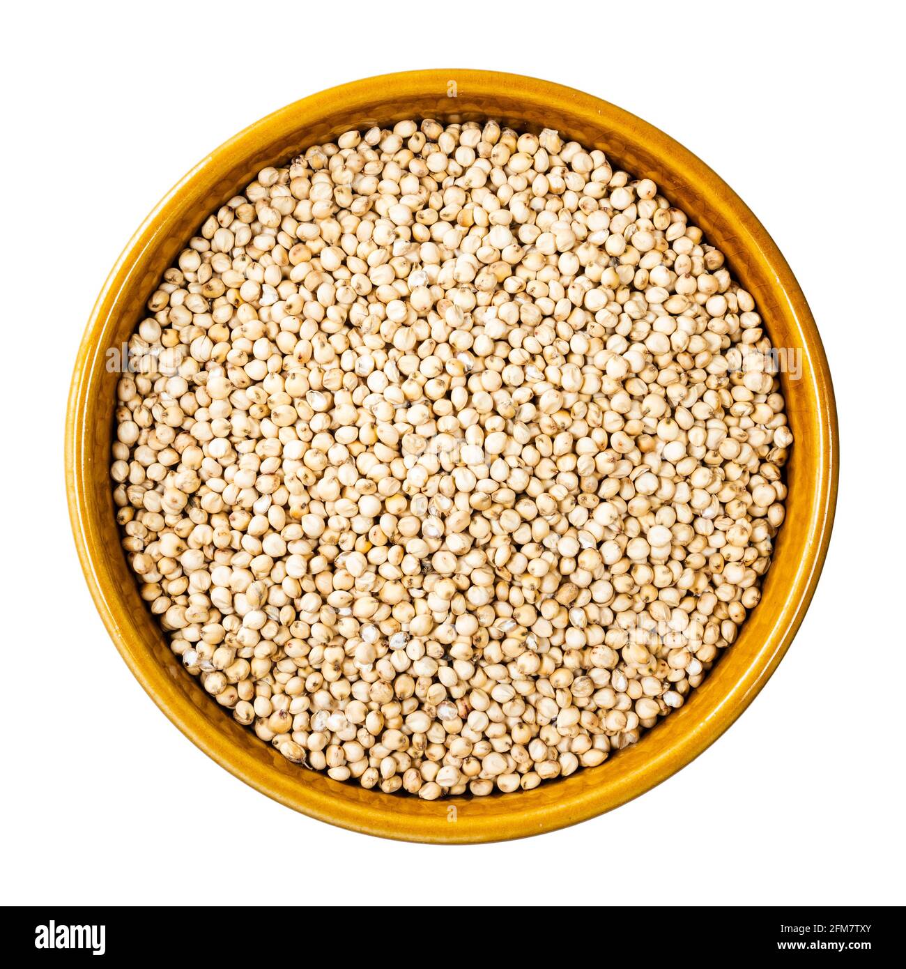 top view of raw unhulled Sorghum grains in round bowl cutout on white ...