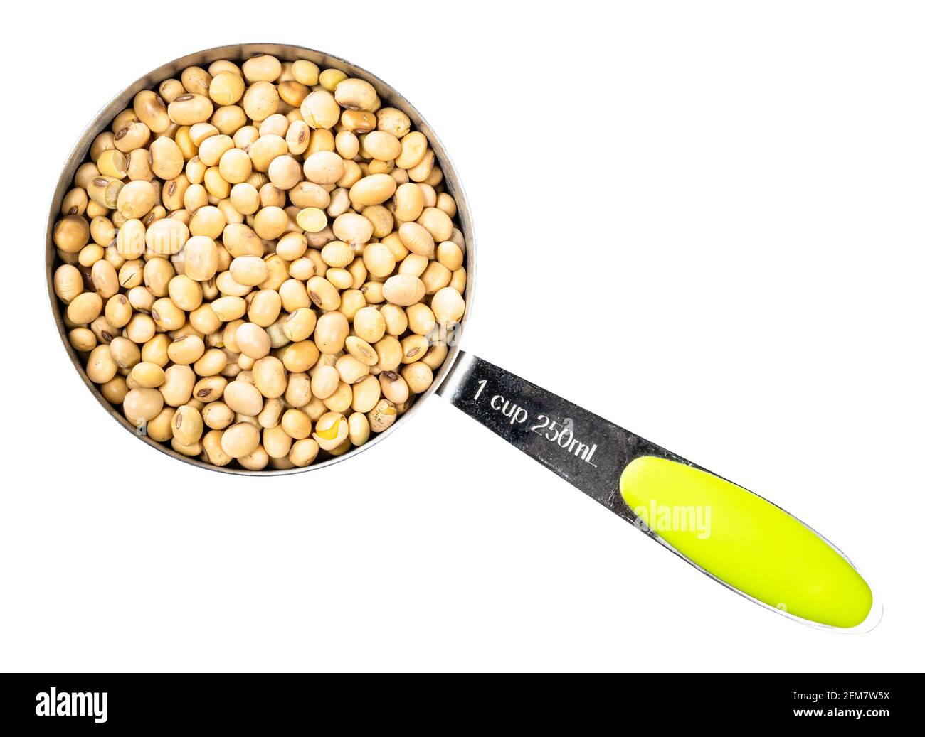 top view of dried soybeans in measuring cup cutout on white background ...