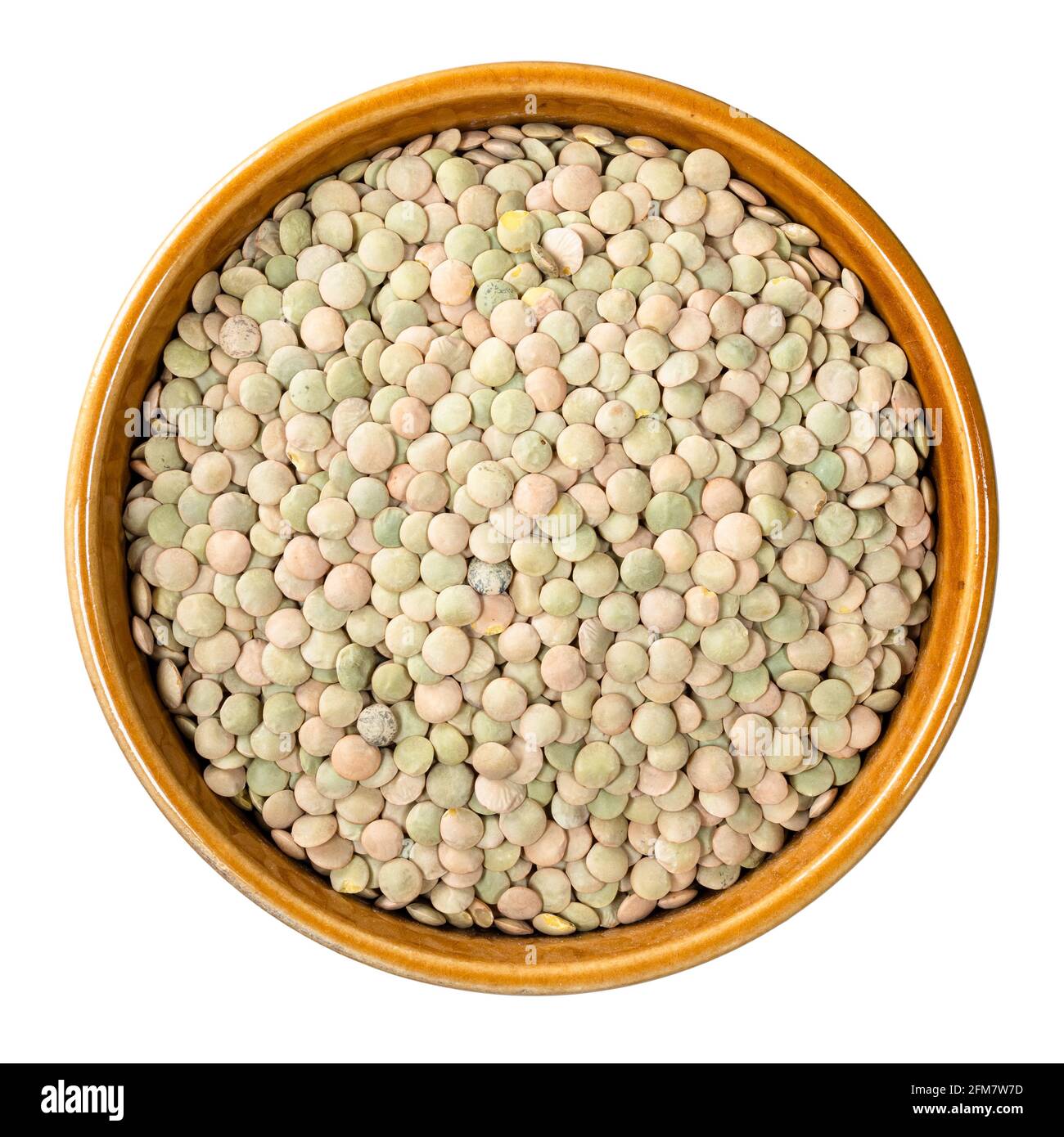 top view of whole large green lentils in round bowl cutout on white ...