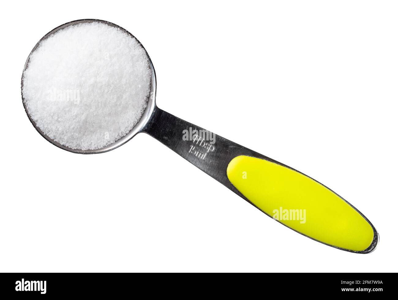 top view of finely ground sea salt in measuring tablespoon cutout on ...