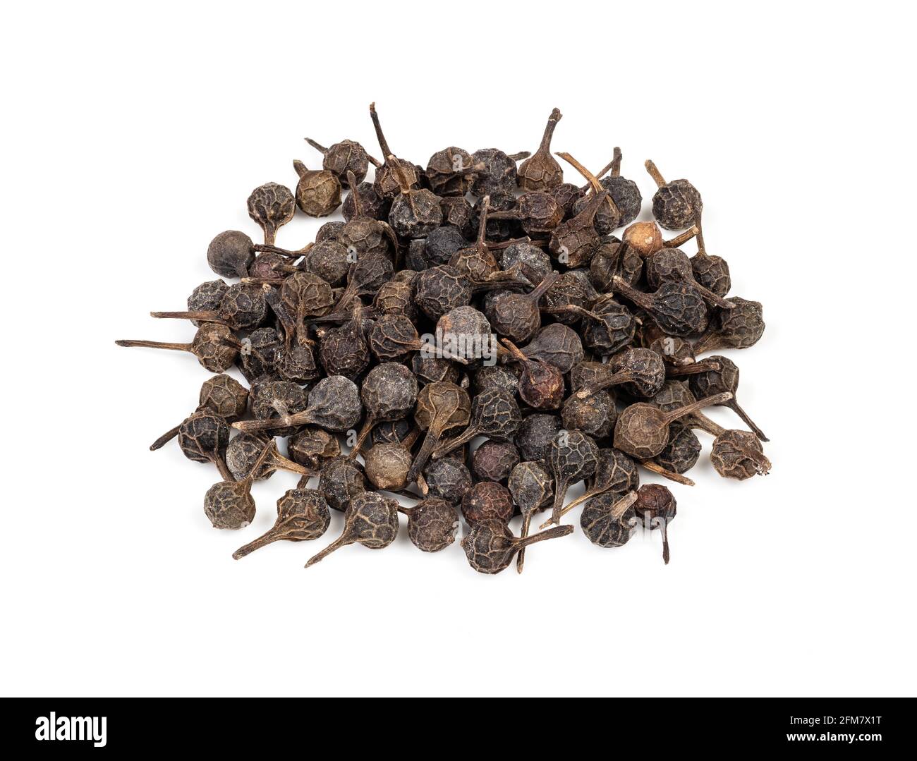 pile of dried cubeb pepper closeup on white background Stock Photo - Alamy