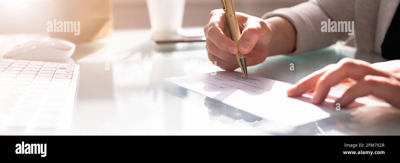 Female hand writing cheque hi-res stock photography and images - Alamy