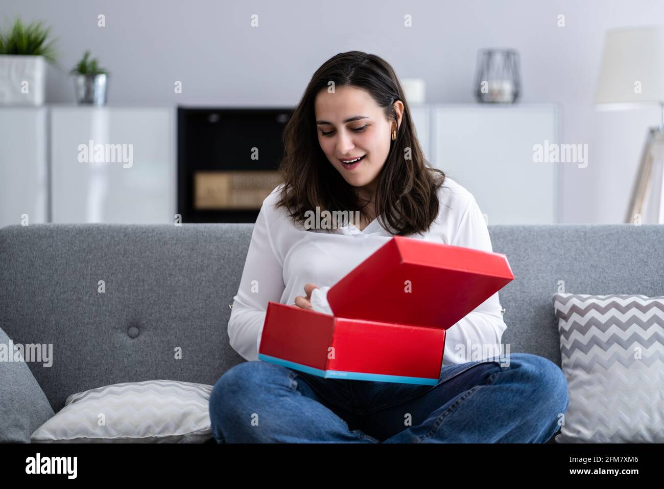 Woman Opening Parcel Gift Box. Happy Ecommerce Shopping Stock Photo - Alamy