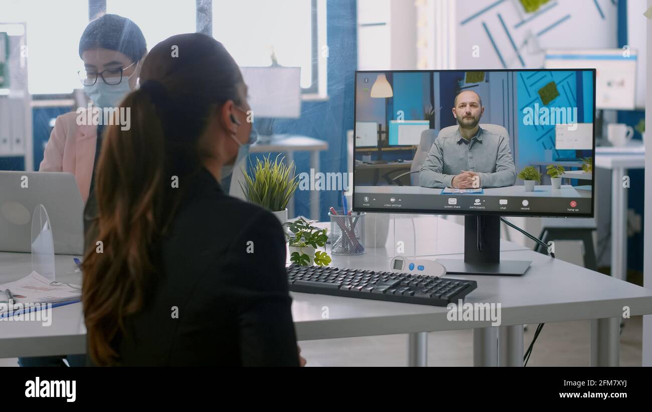 Back shot of businesswoman wearing medical face mask talking on ...