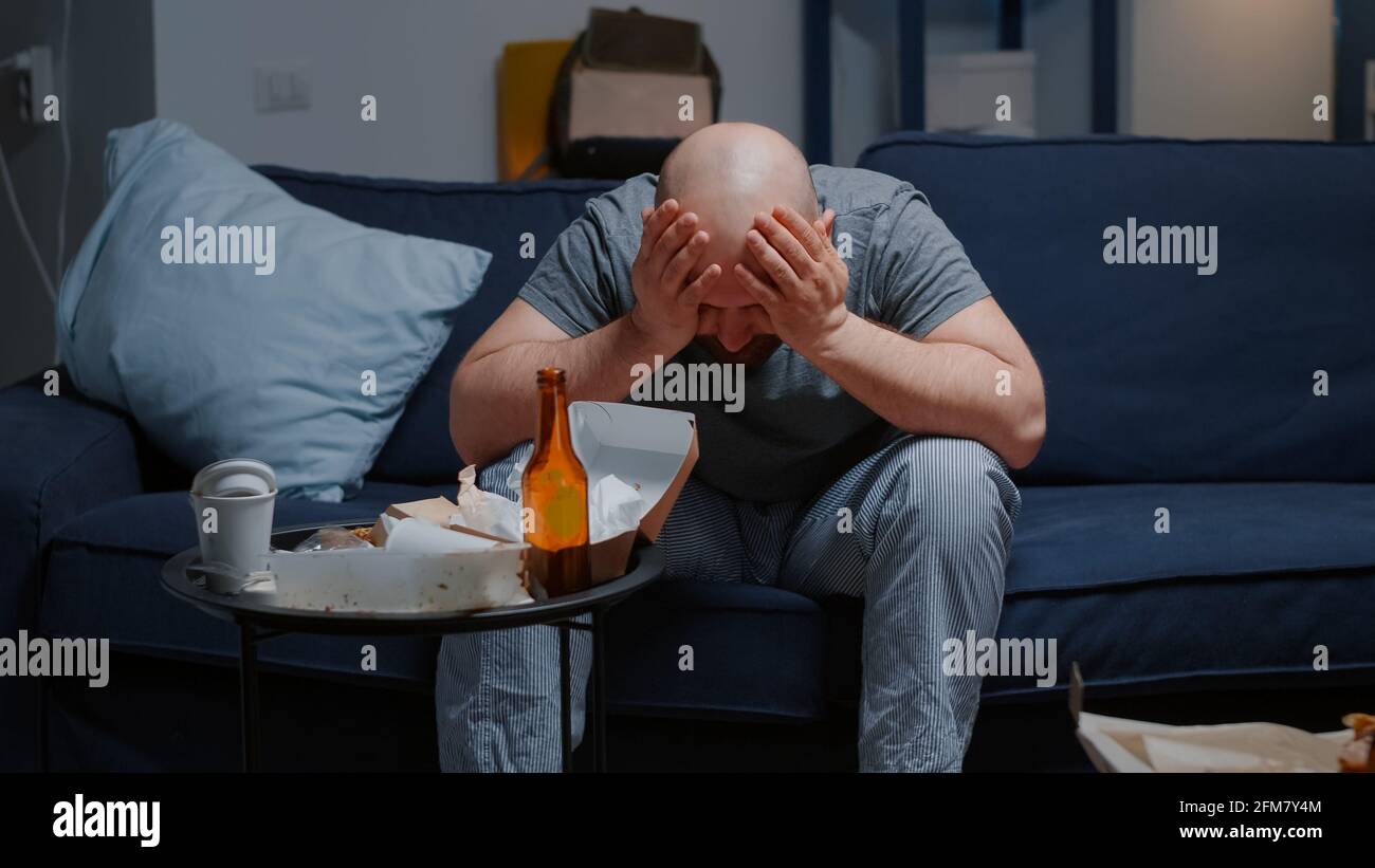 Breakdown depressed worried hopeless man with tears sitting on couch ...
