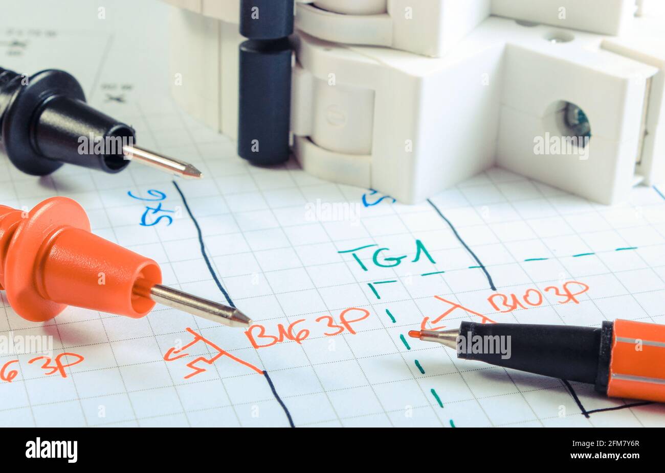 Cables of multimeter and electric fuse on construction drawing of house ...