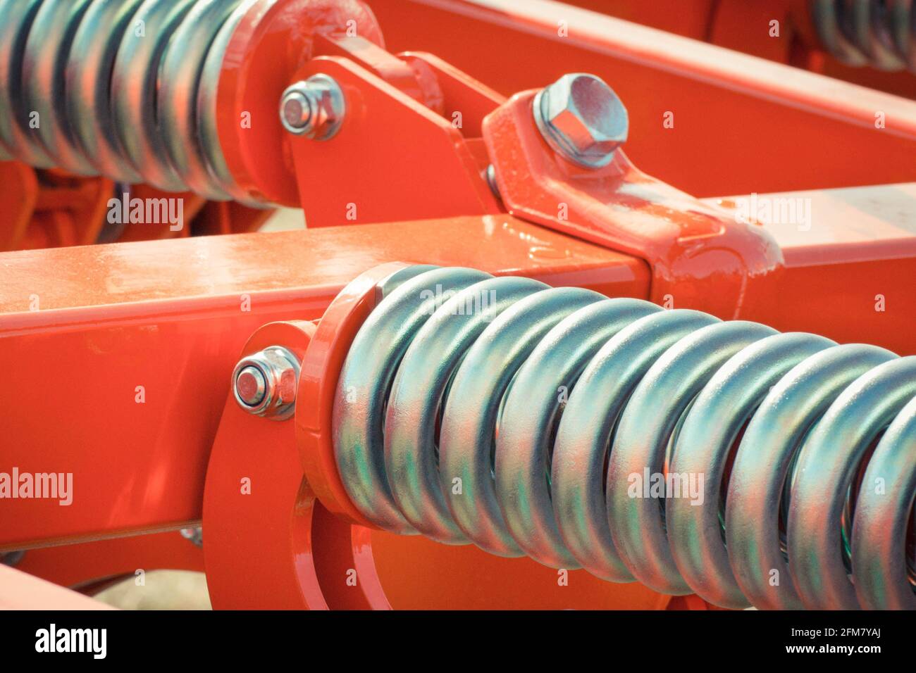 Big and hard steel silver spring as part and detail of red industrial ...