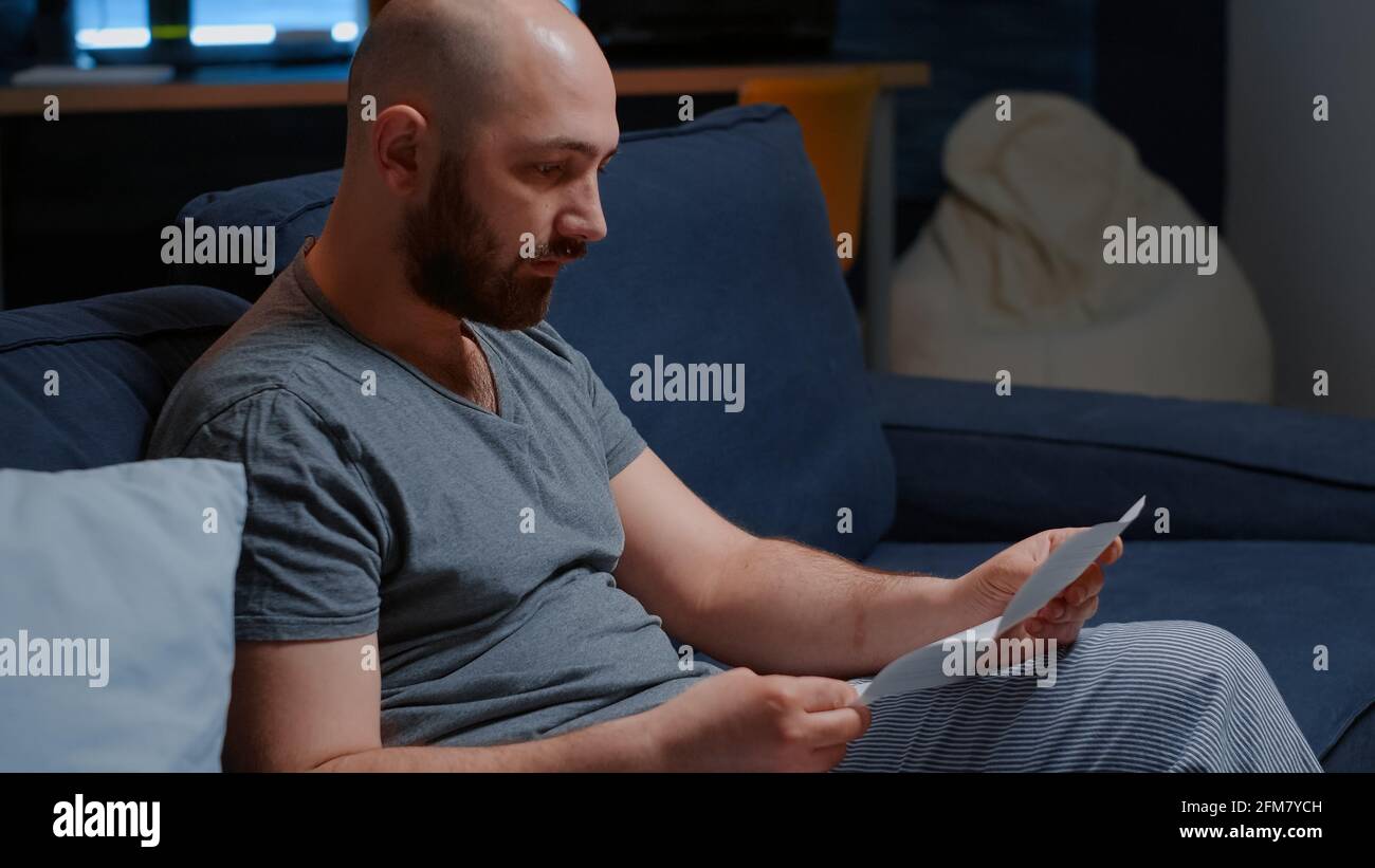 Angry stressed depressed man reading bad news in mail letter feeling ...