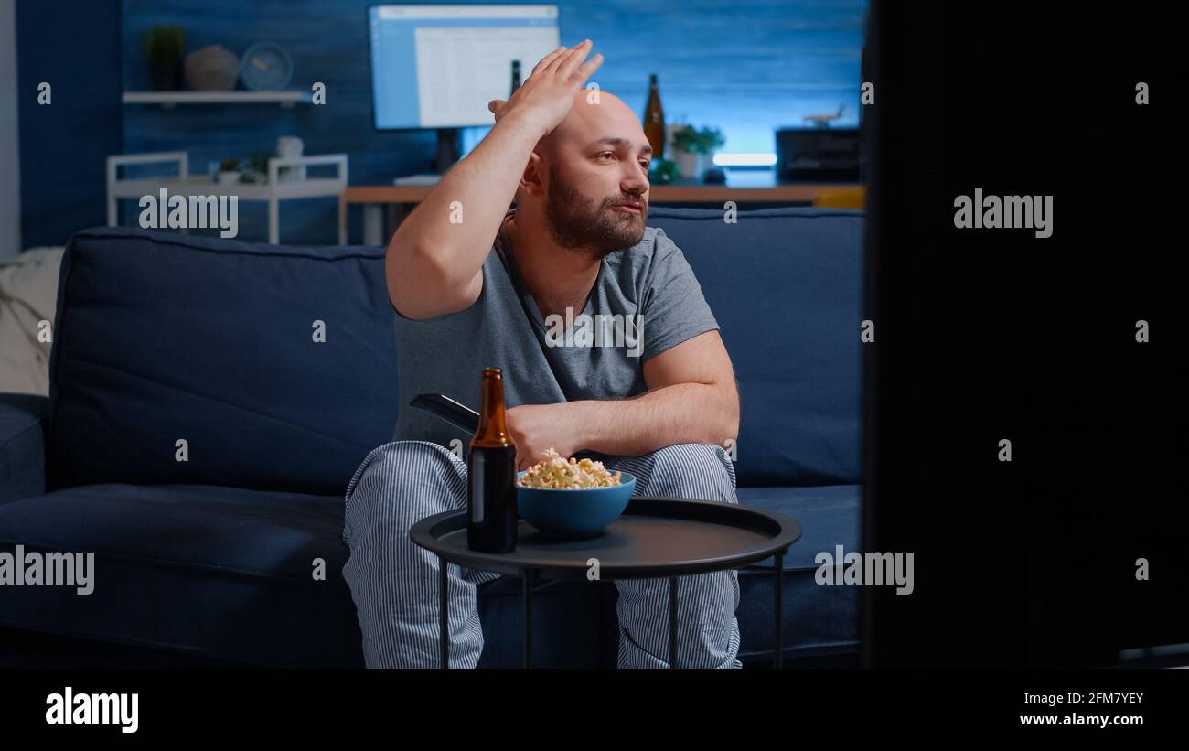 Man alone watching tv talking hi-res stock photography and images - Alamy