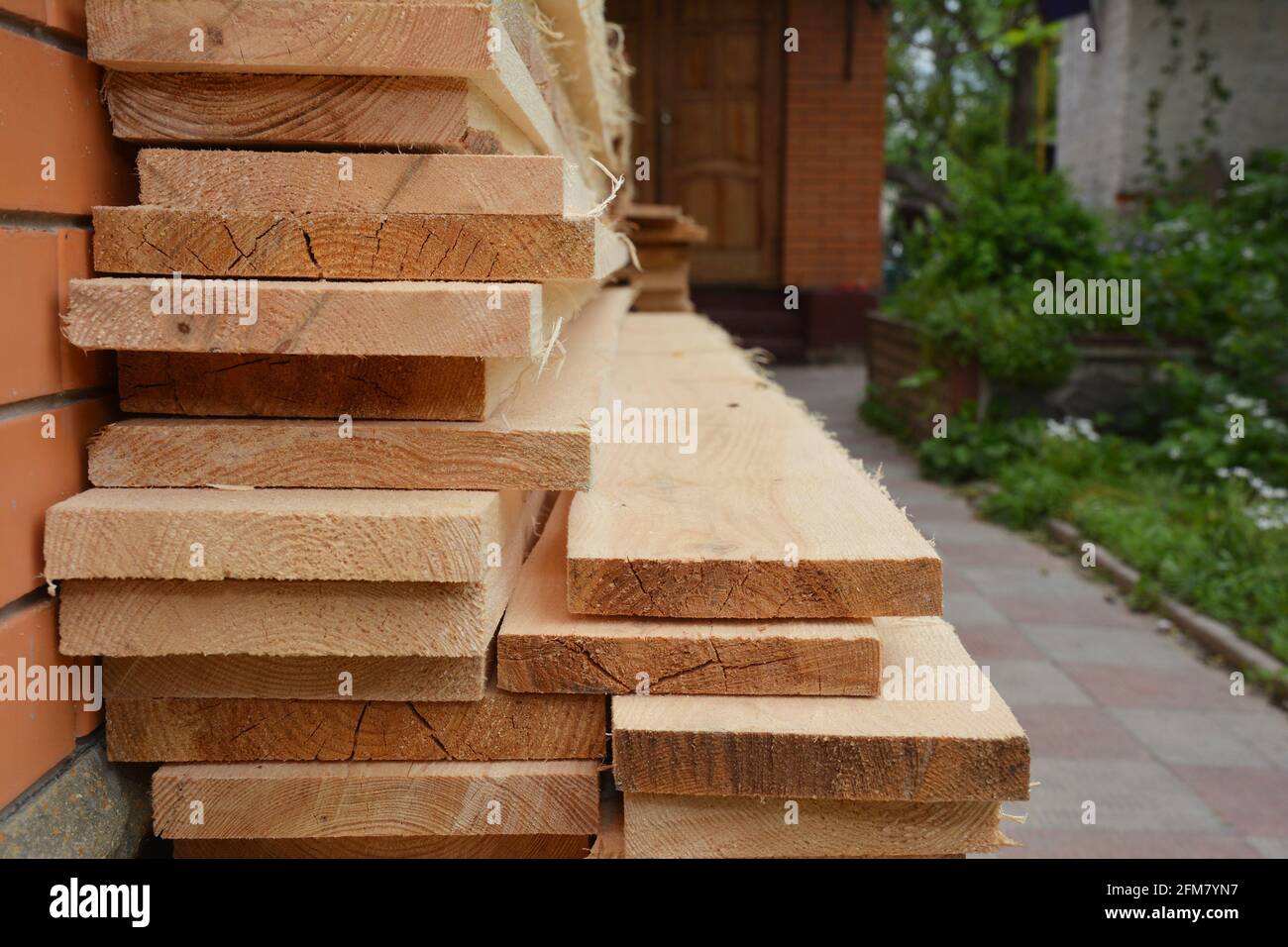 Wooden building materials: A stack of wood boards, planks and sawn ...