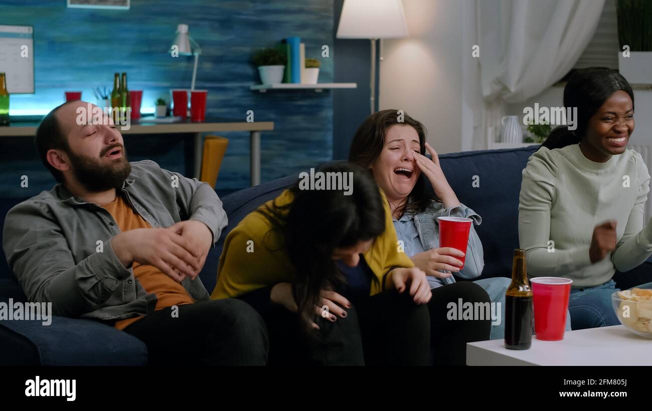 Multiethnic friends having funny reaction while watching comedy movie ...