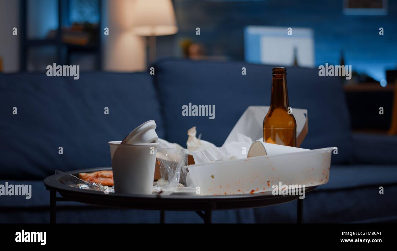 Messy empty living room of depressed person with scattered food mess ...