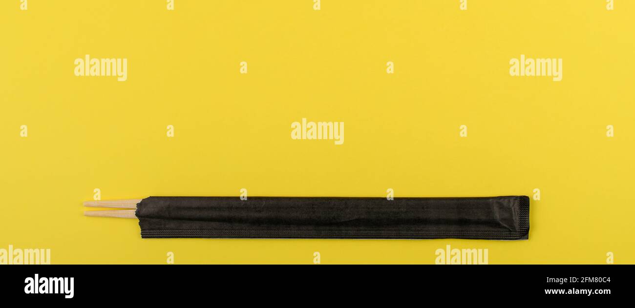 Wooden chopsticks on yellow background. Wide banner. Flat lay, top view ...
