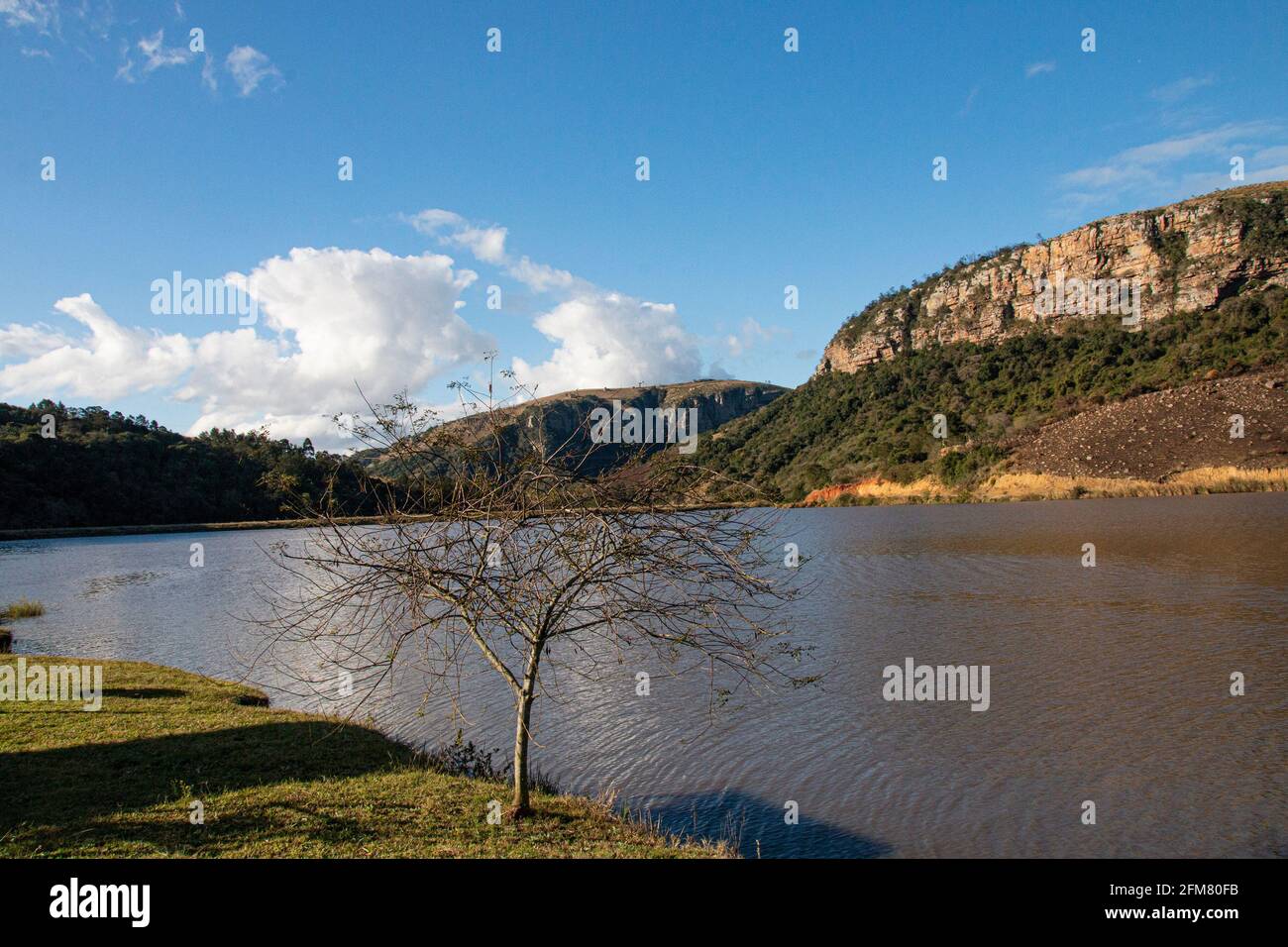 Natural dam surounded by hills and local vegetation Stock Photo - Alamy