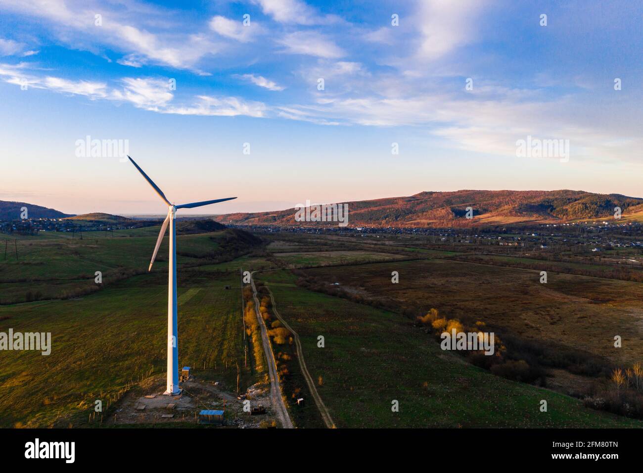 Panoramic landscape from the country road to the wind turbine, the ...