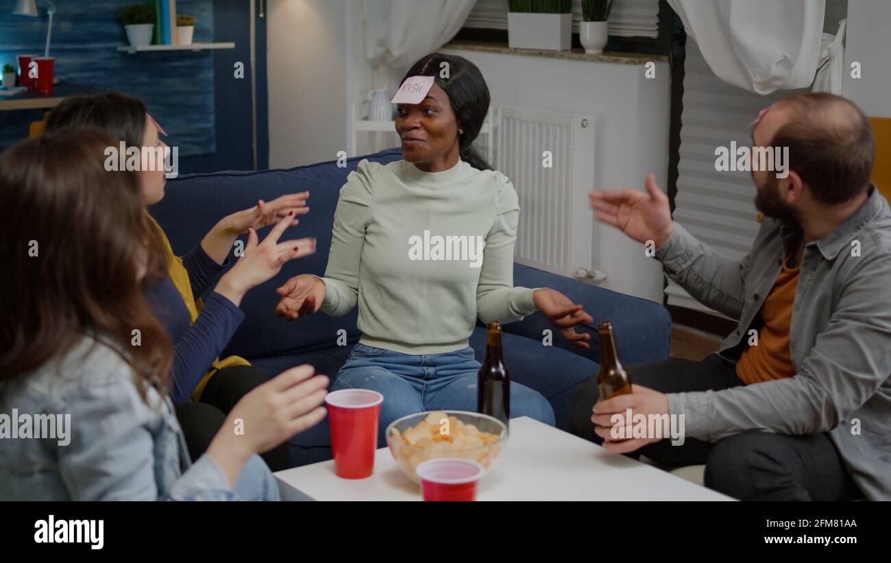 Group of multiethnic friends with sticky notes putting on forehead ...