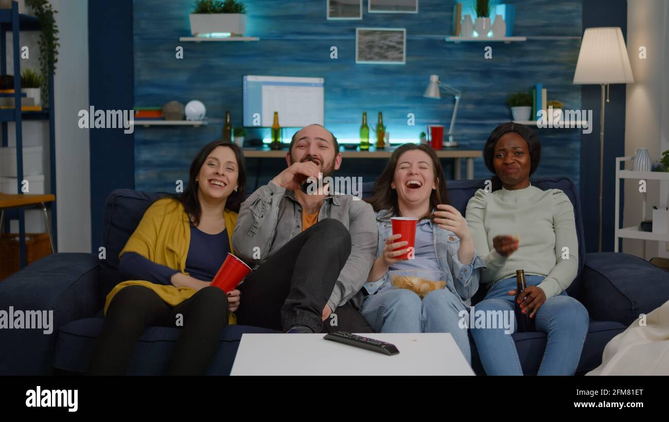 Multiethnic friends laughing while watching comedy movie enjoying time ...