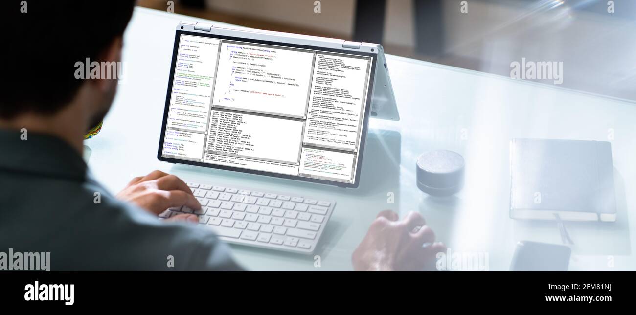 Programmer Or Coder At Office Desk Using Laptop Stock Photo - Alamy
