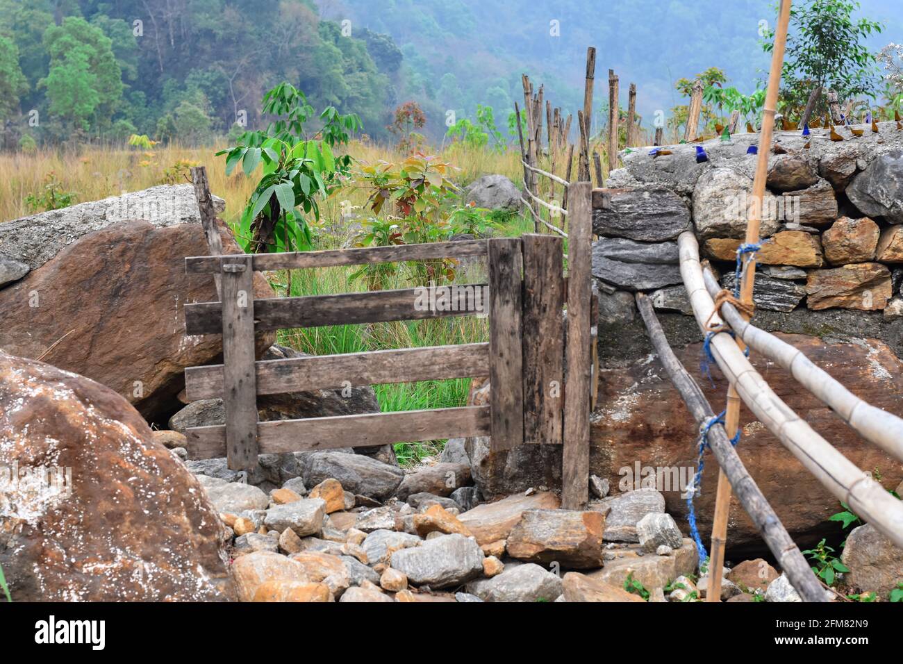 Stone and boulders fencing with a wooden gate of a farm Stock Photo - Alamy