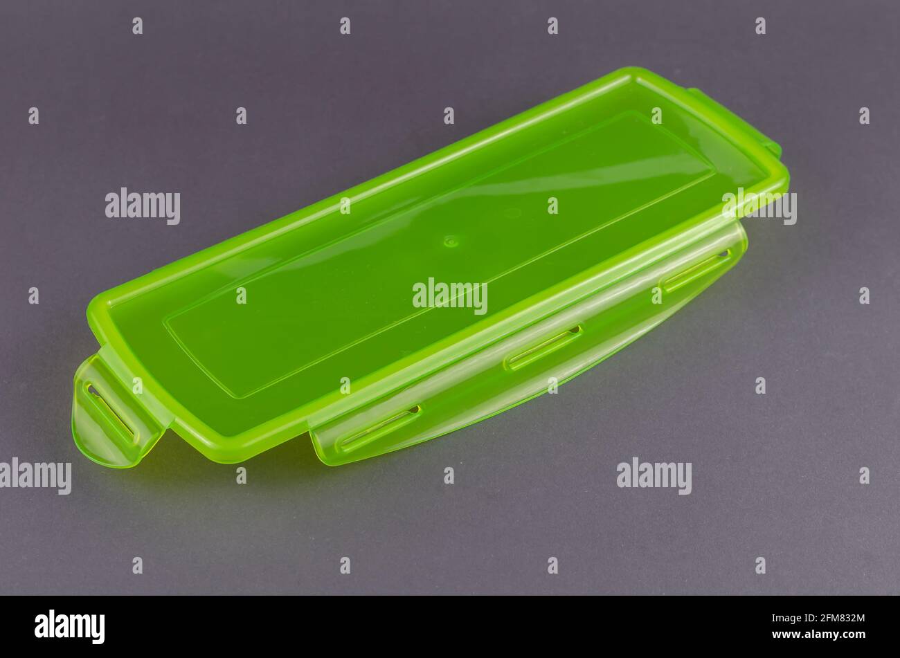 Green plastic lid for food container. Transparent rectangular lid on ...