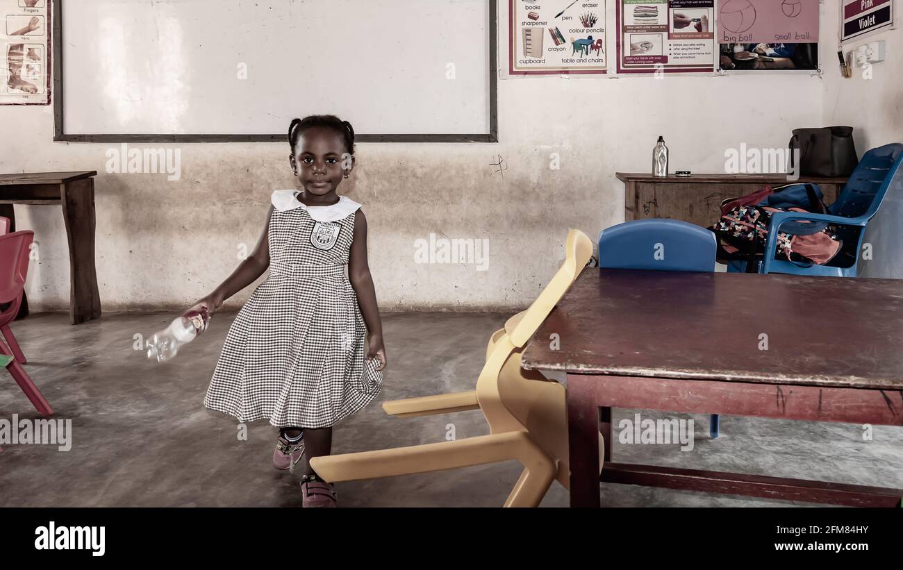 Girl left alone in the classroom after the lesson and waiting to go ...