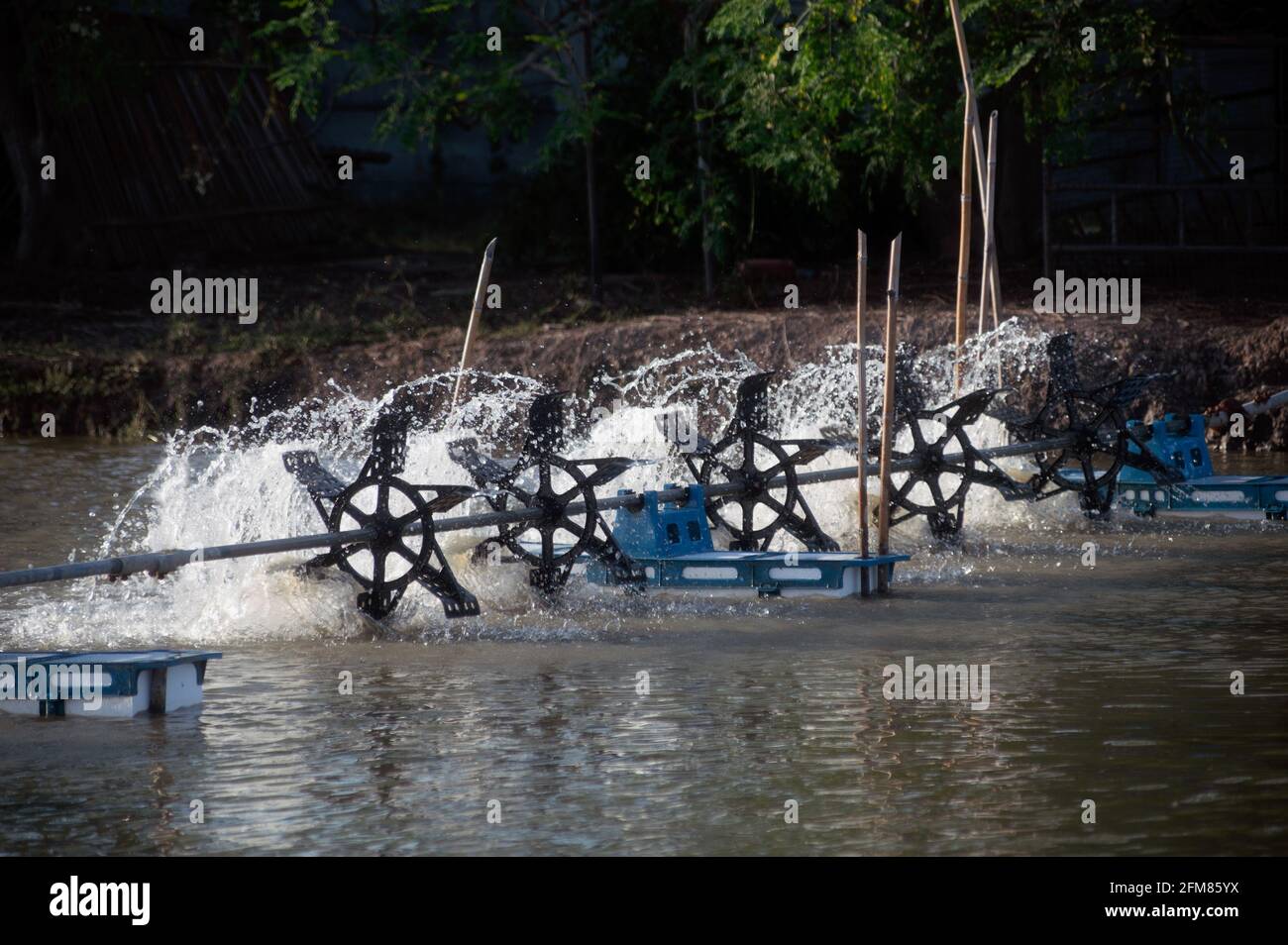 A water turbine used to rotate the water in the aquaculture pond with a ...