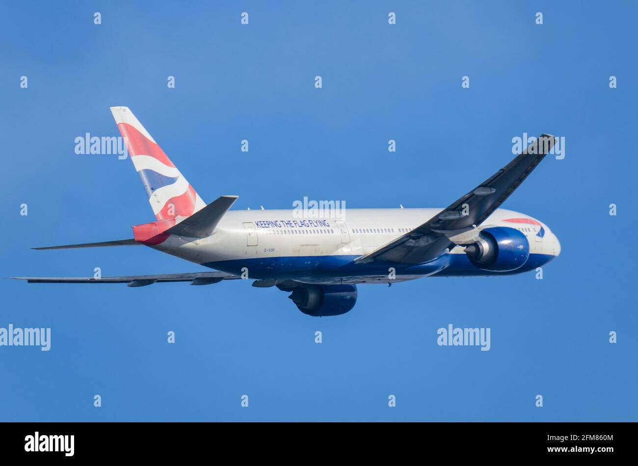 British Airways Boeing 777 jet plane G-VIIH climbing out after take off ...