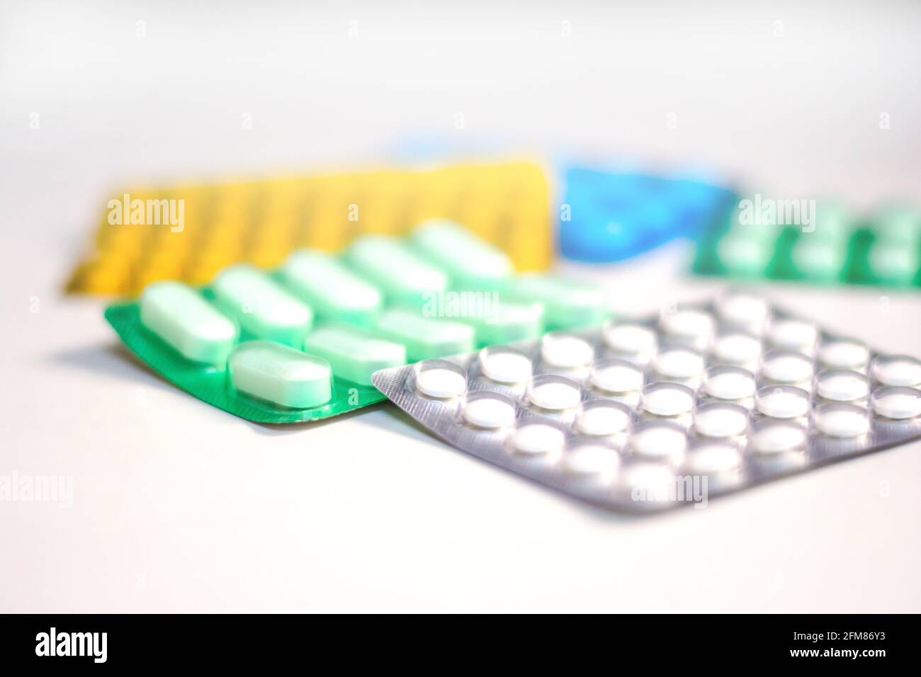 Colorful Many pills and tablets isolated on white background ...
