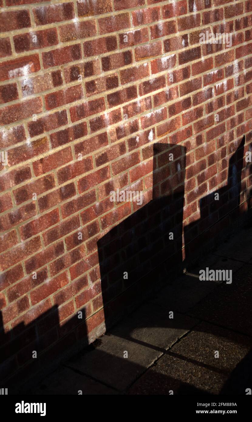 chair in shadow against wall Stock Photo - Alamy
