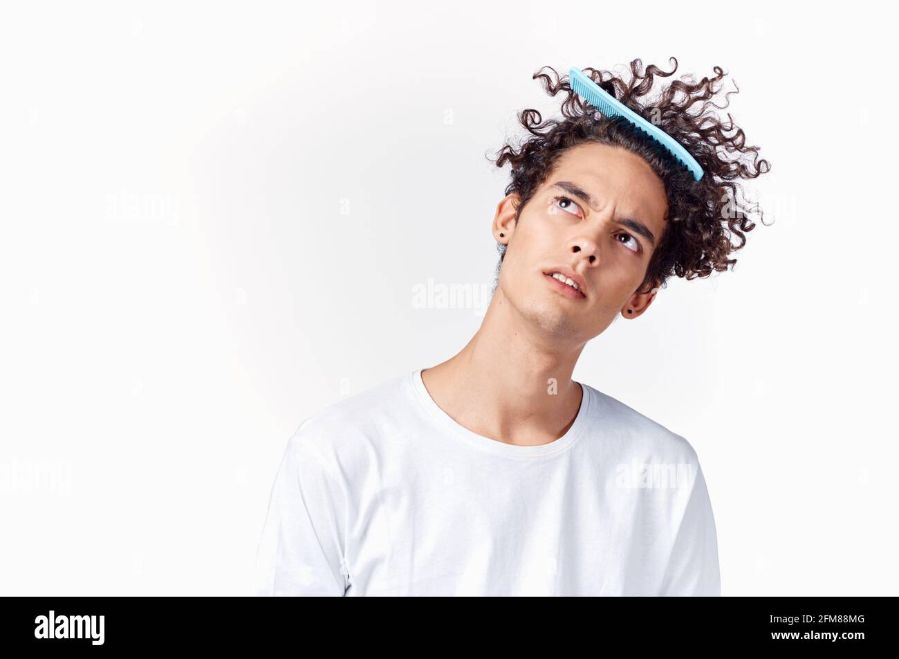 emotional man with comb curly hair close-up Stock Photo - Alamy