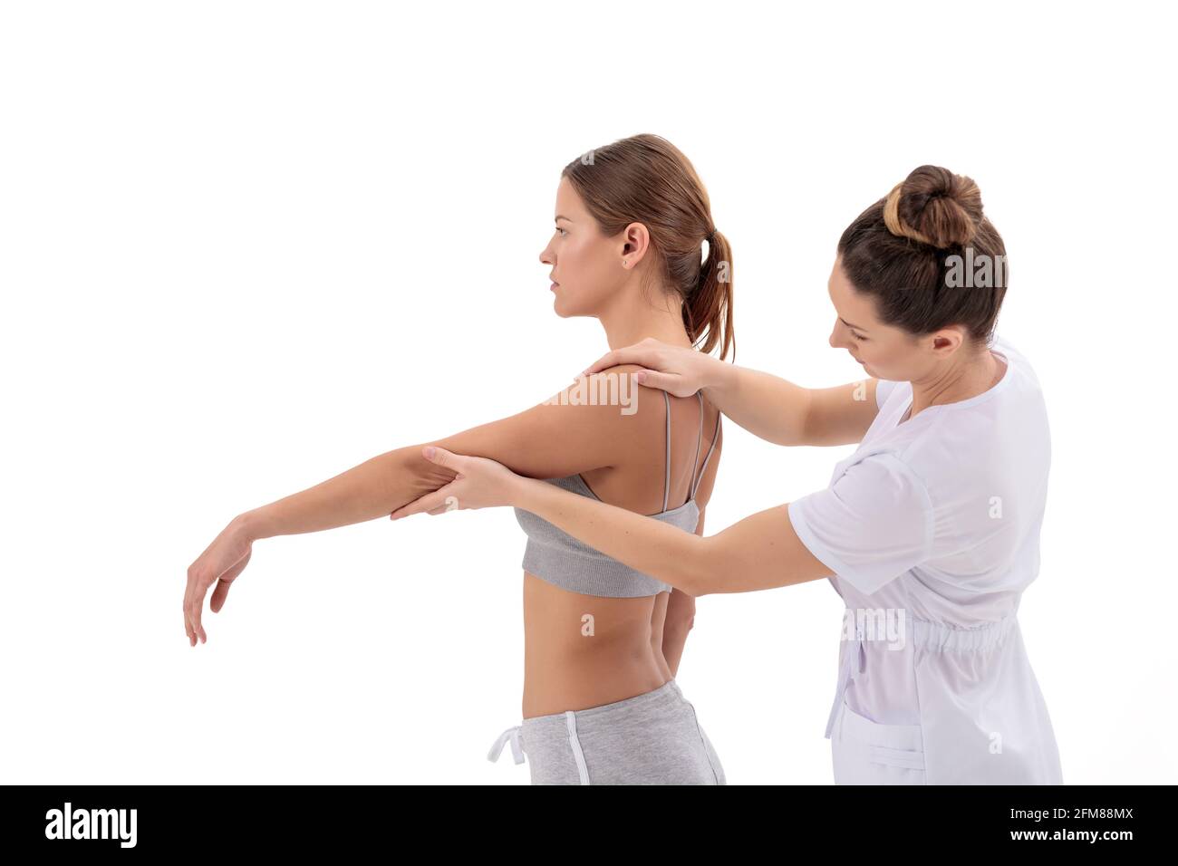 Female Patient at the physiotherapy doing physical exercises with ...