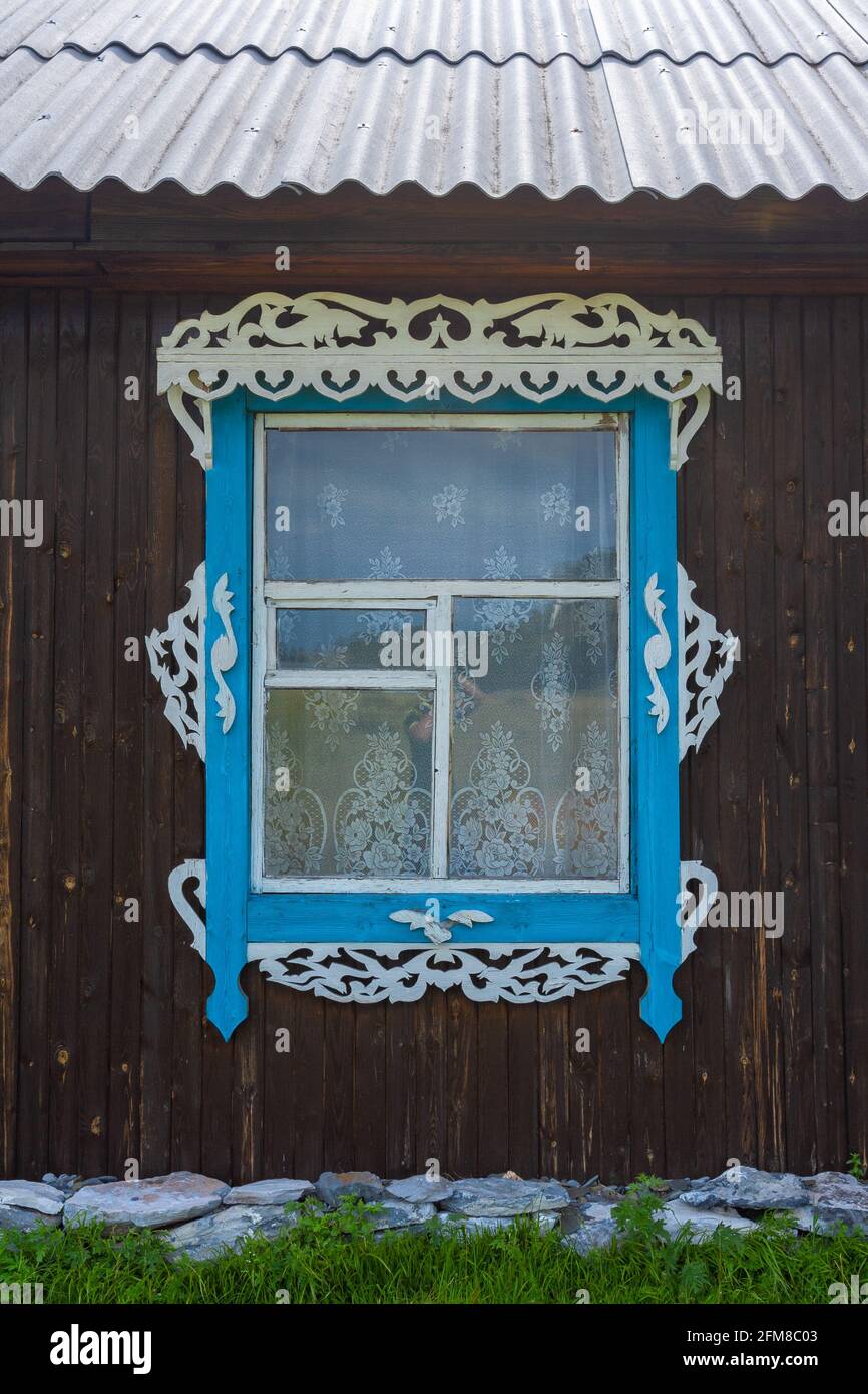 Old Russian window with carved frame with wooden wall and slate roof ...