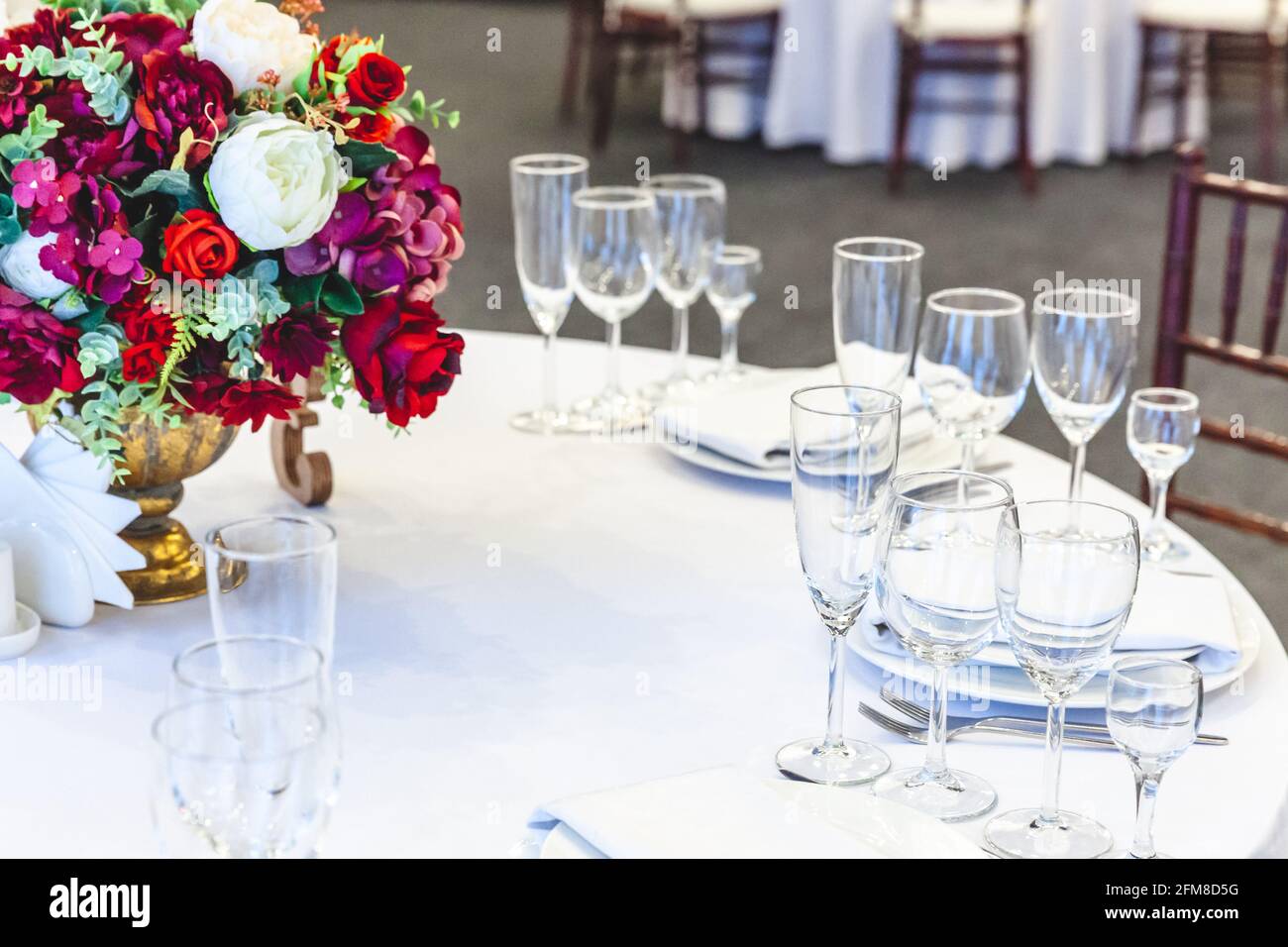 Fancy table set for dinner with flower composition in restaurant ...