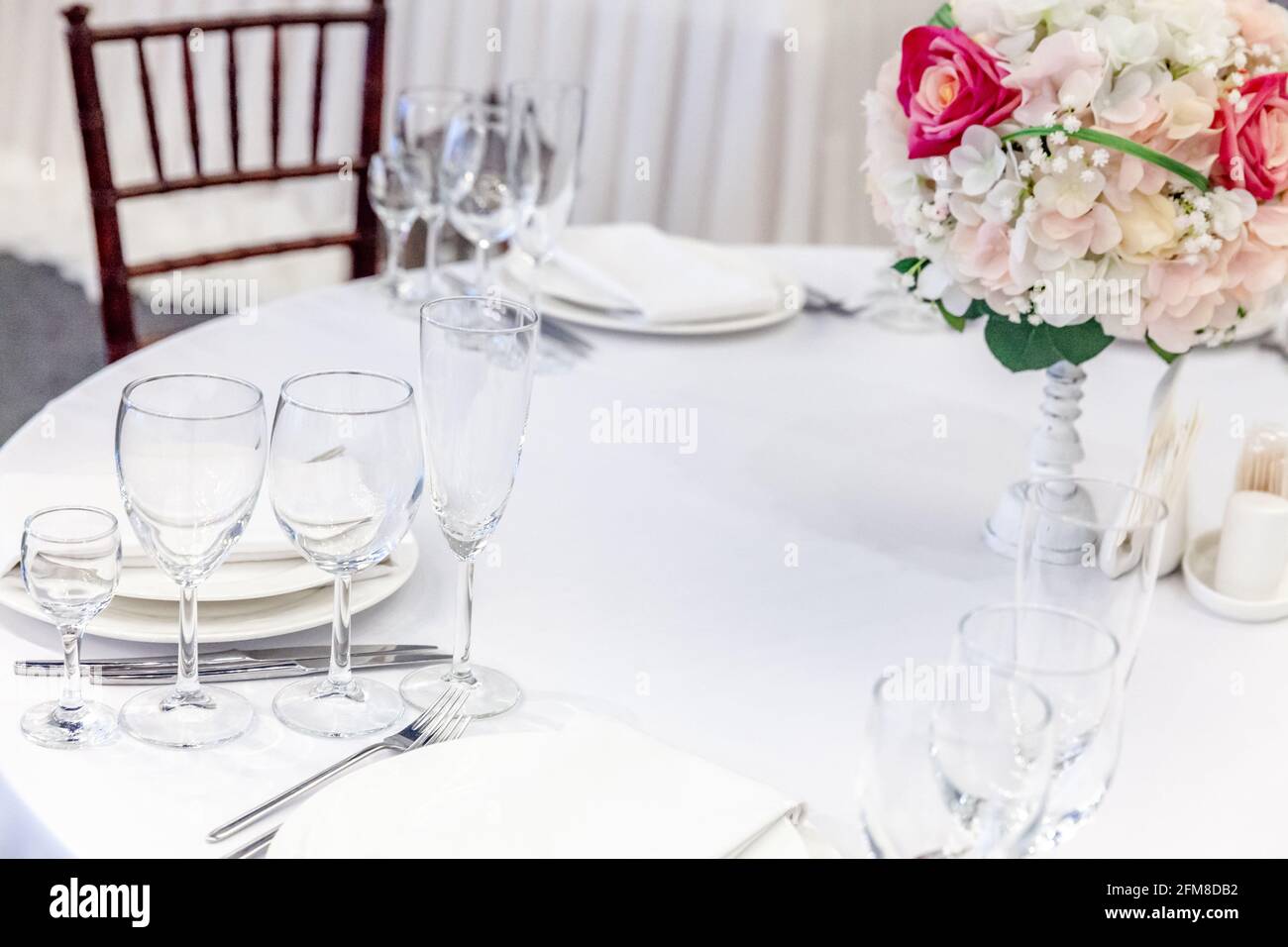 Fancy table set for dinner with flower composition in restaurant ...