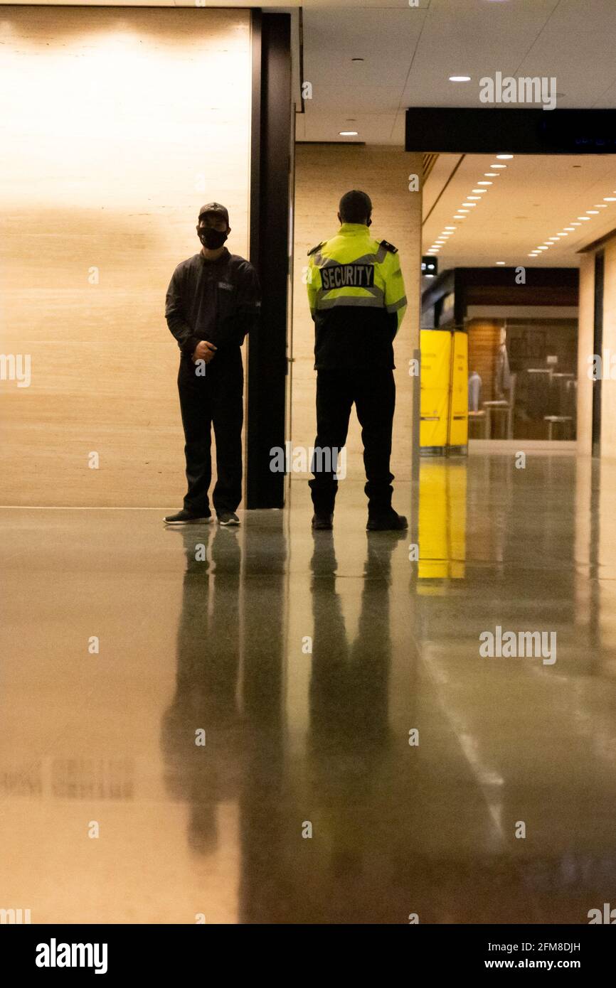 A low-angle shot of security guards patrolling inside a commercial ...