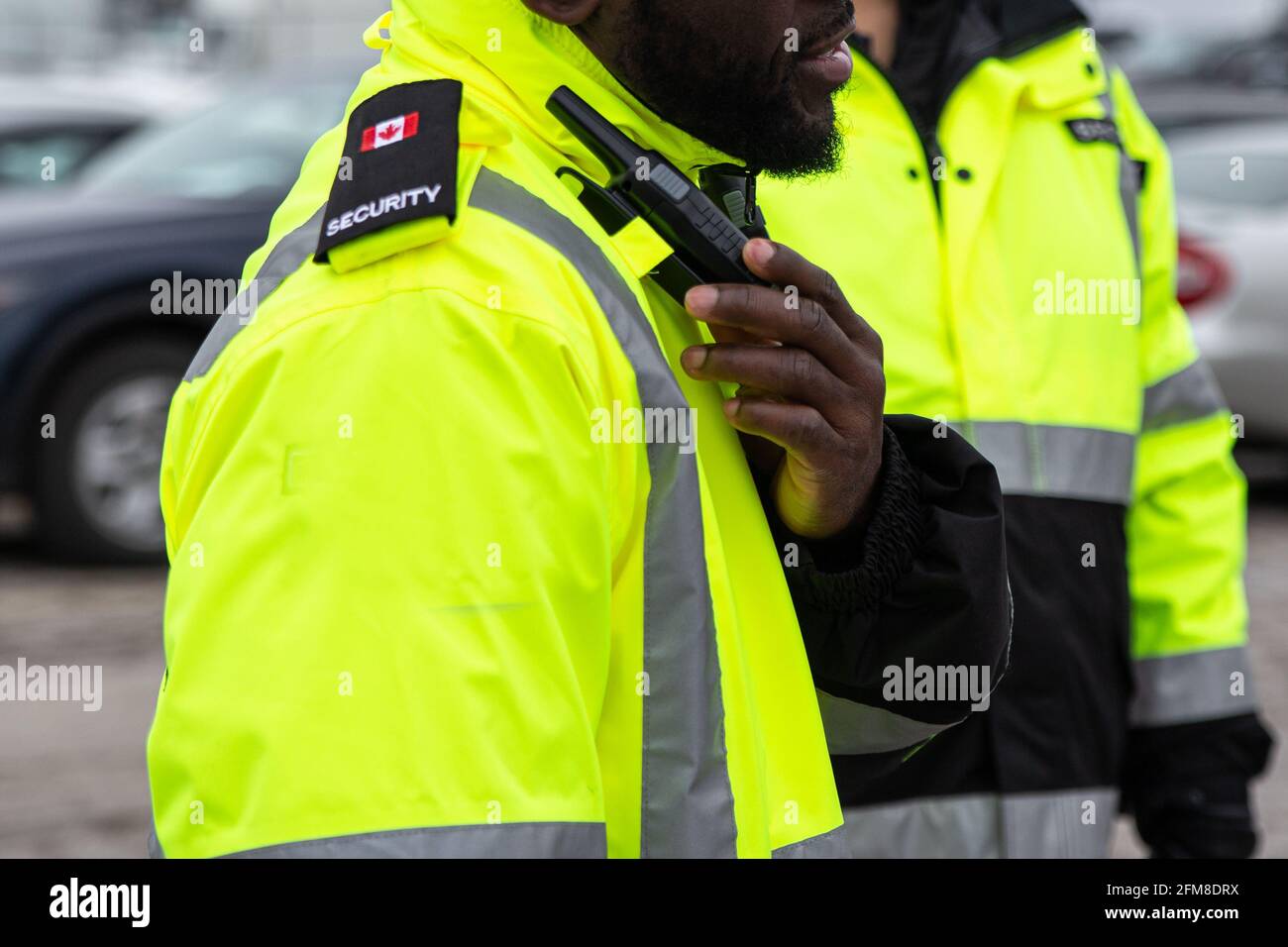 Parking security is watching over parking area and using a walkie ...