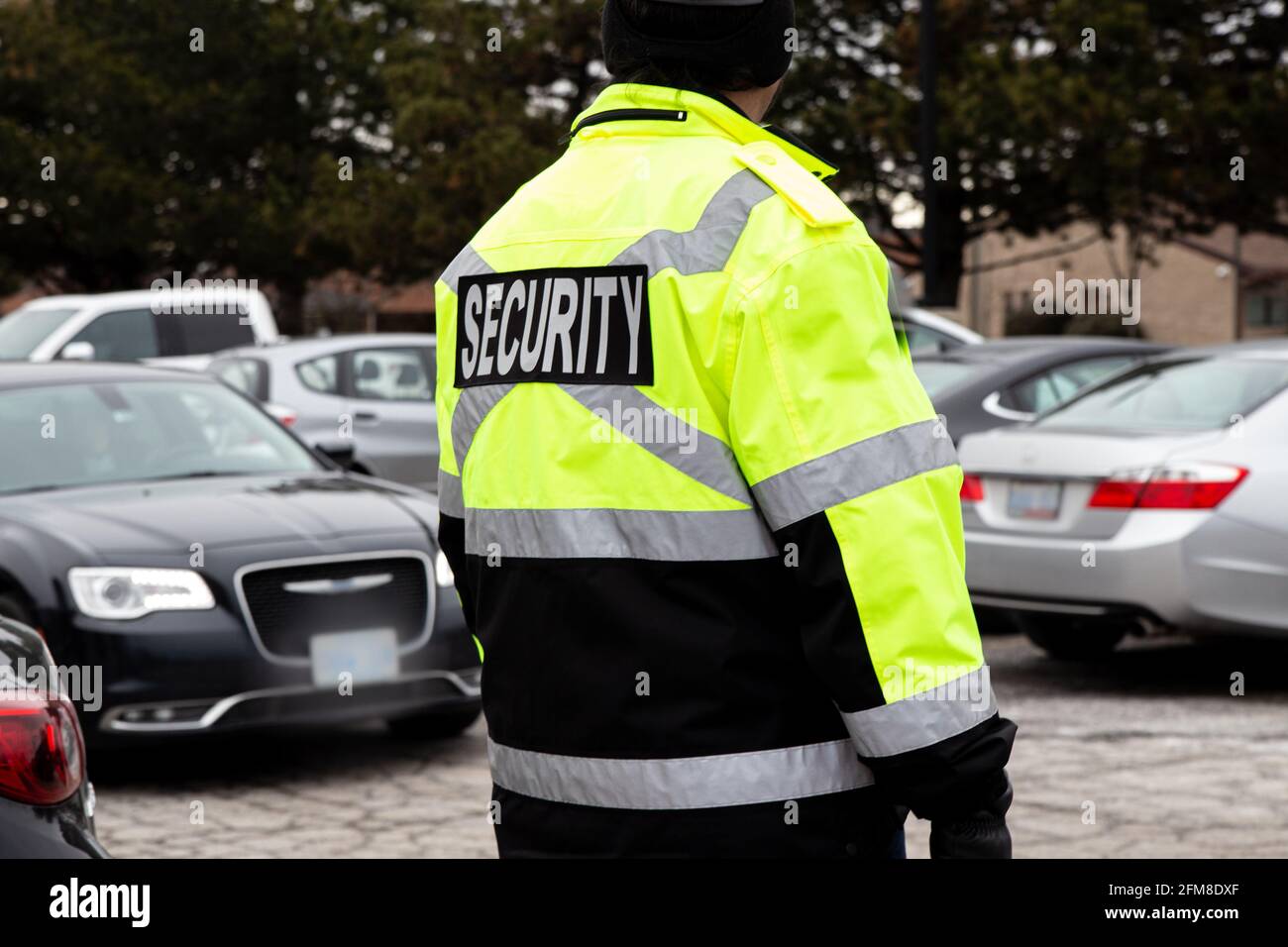 A rear view of parking security watching over parking area. Security ...