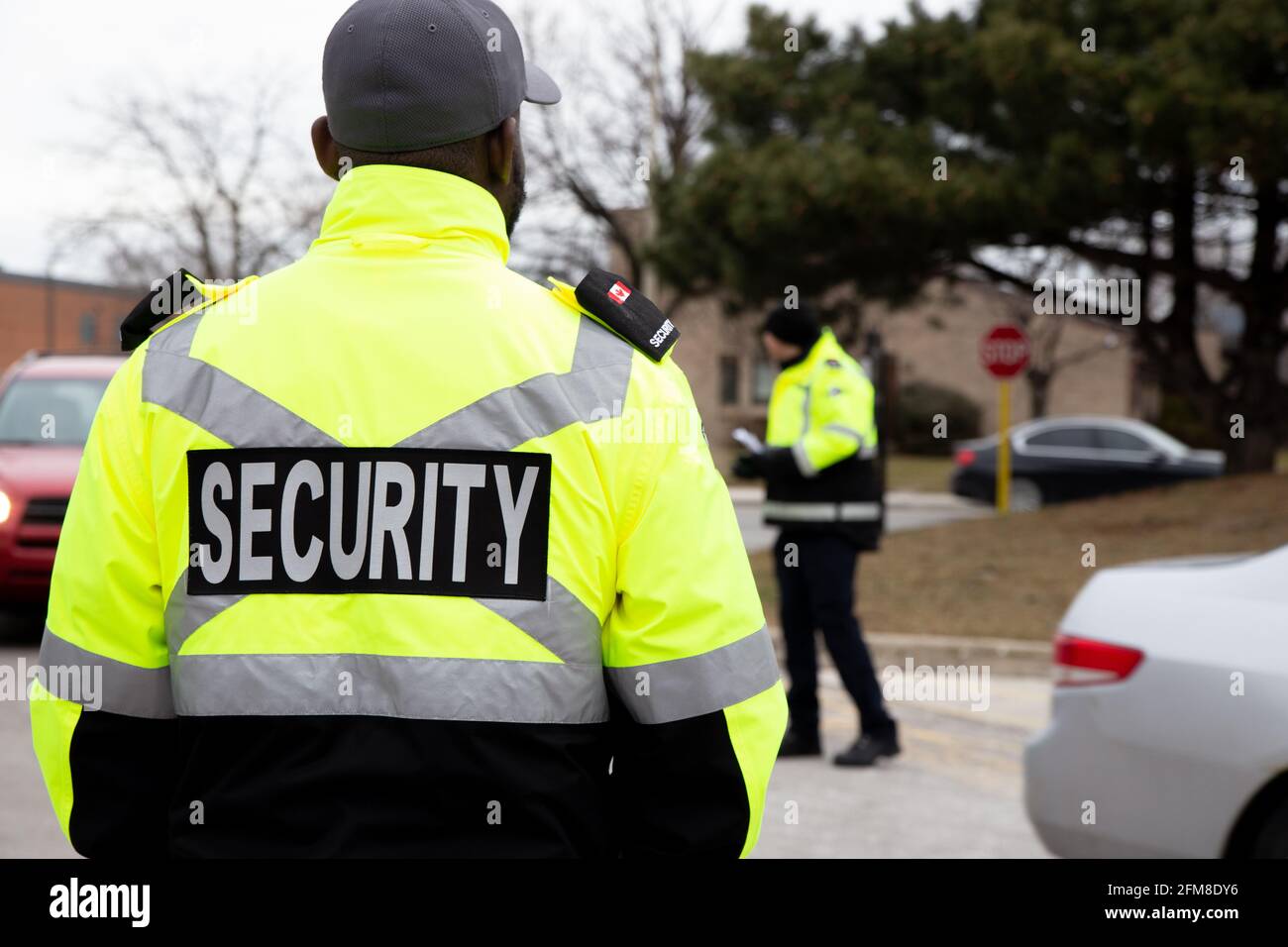 A rear view of parking security watching over parking area. Security ...