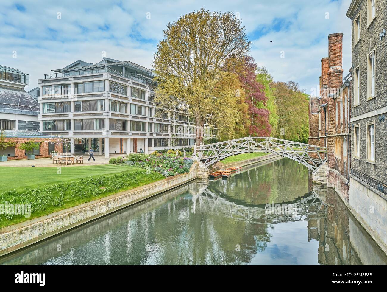 A student walks through Queens' college, university of Cambridge ...