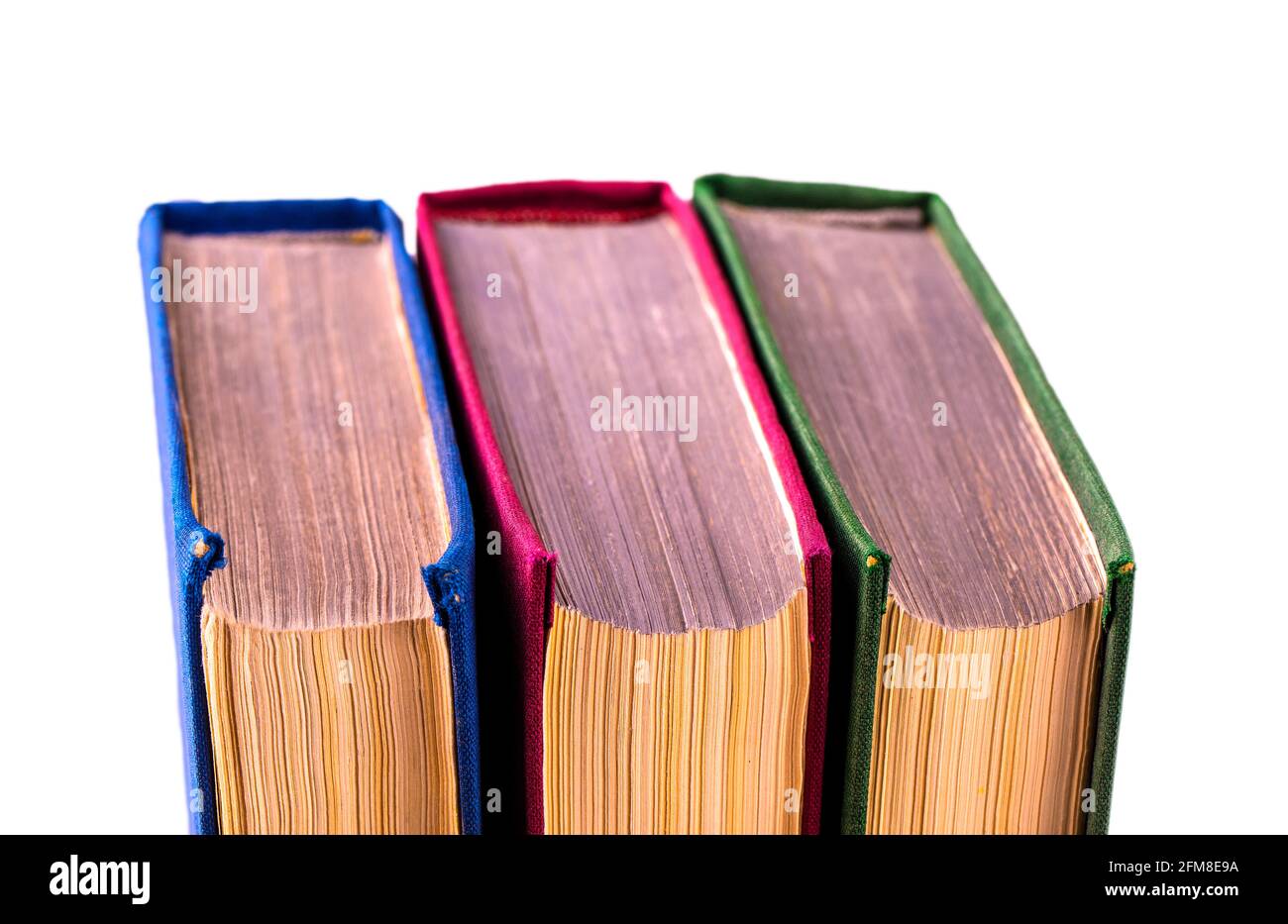 Three old books turned back side shot close-up cut out on a white ...