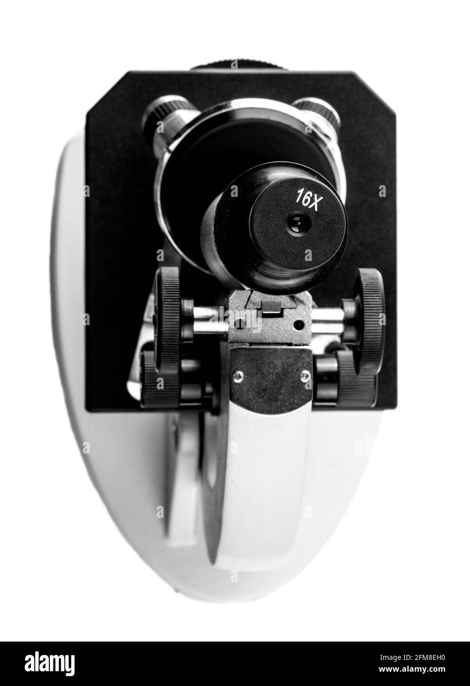 school microscope with lens shot above the cut out on white background ...