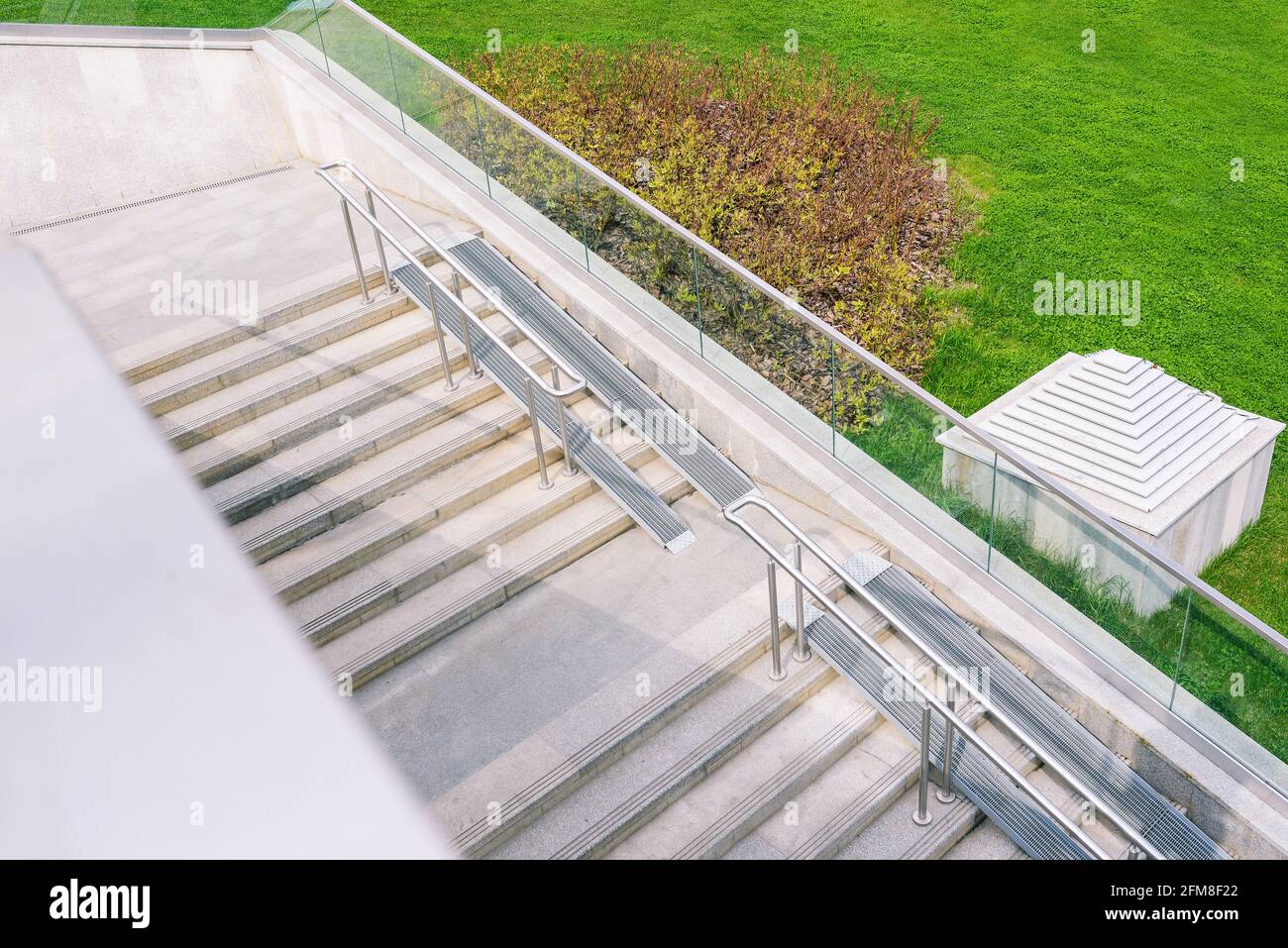Gray staircase with a ramp for the disabled. Urban architecture. Exit ...