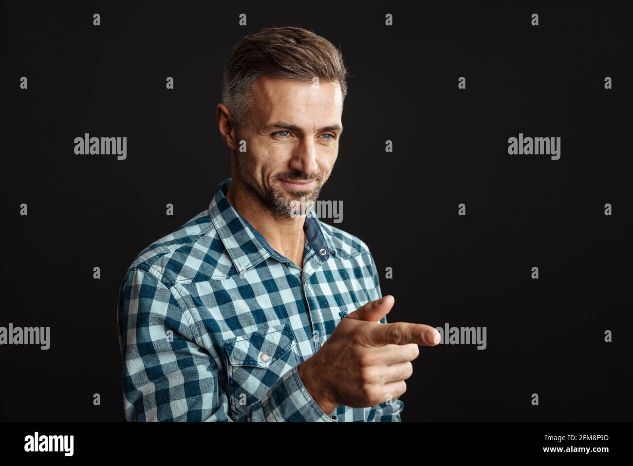 Picture of a handsome smiling grey-haired man pointing isolated over ...