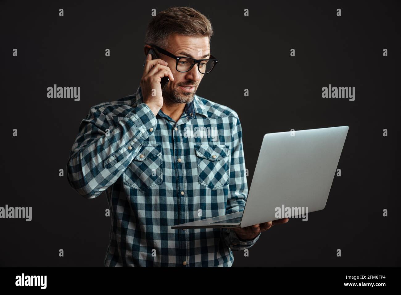 Image of grey-haired confused man isolated over grey wall background ...