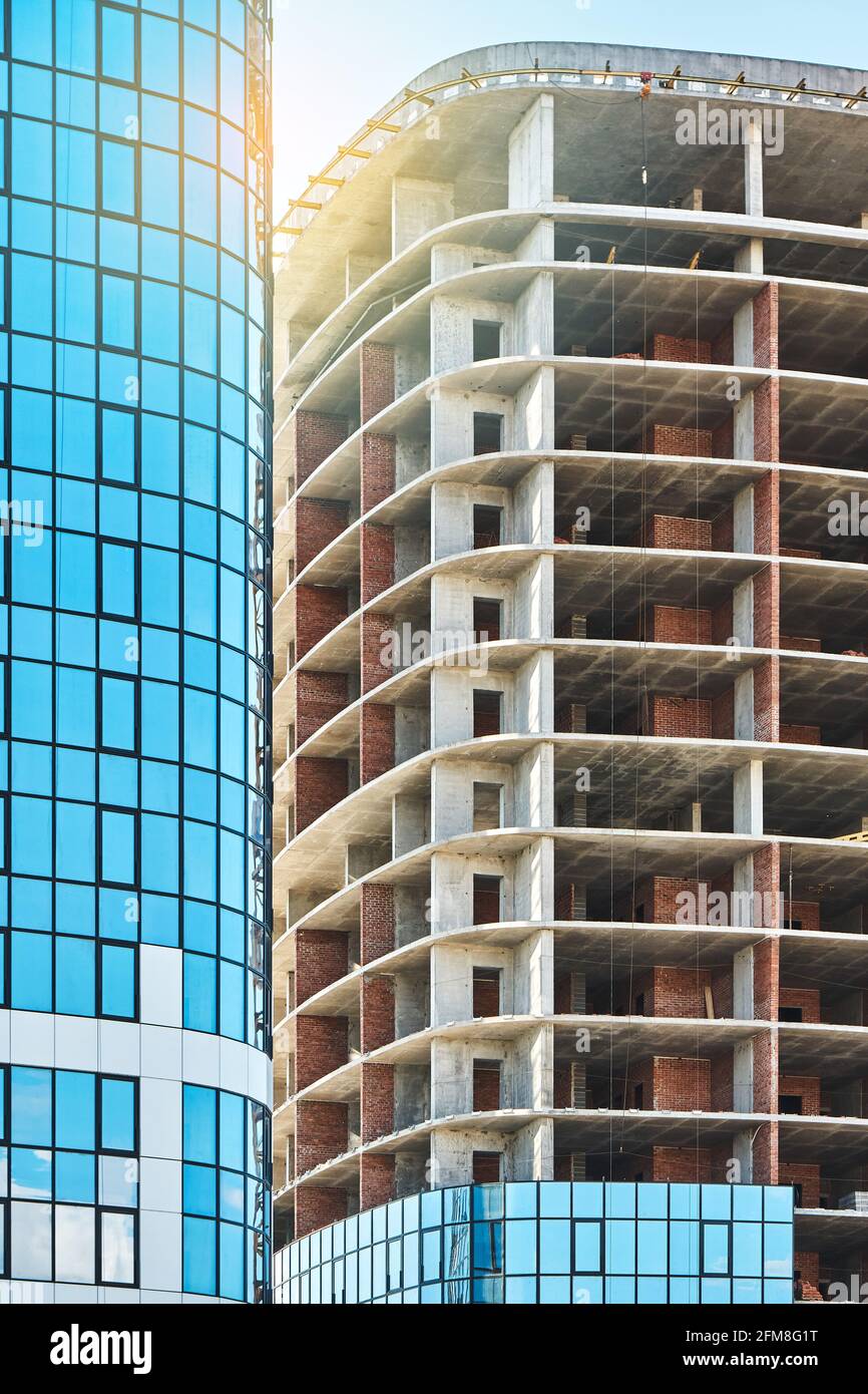 Contemporary skyscraper building with blue glass facade and highrise ...