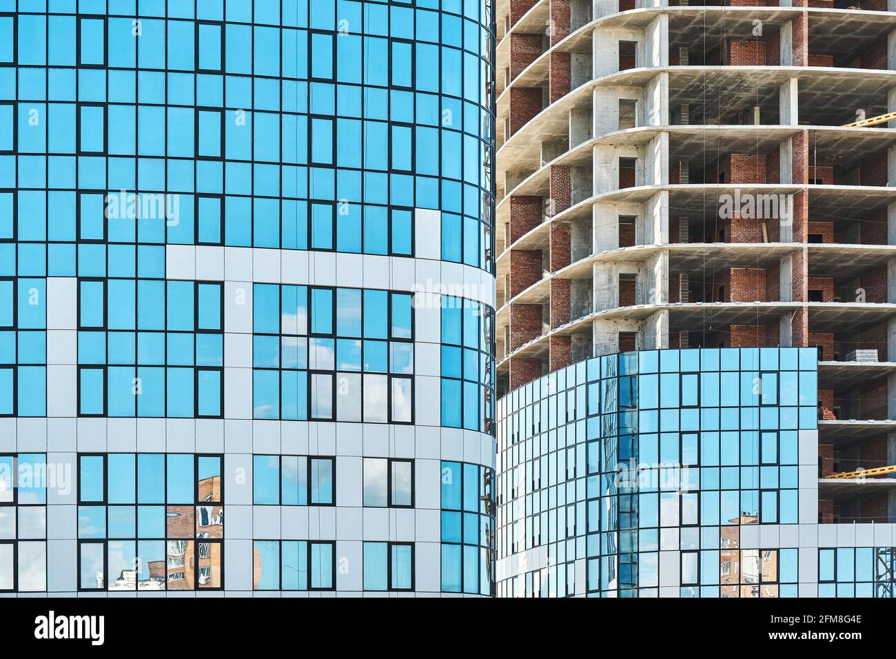 Contemporary skyscraper building with blue glass facade and highrise ...